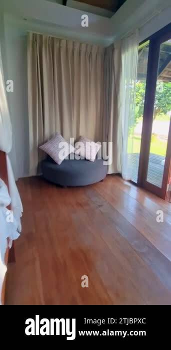 Young men waking up walking outside to his balcony watching the ocean ...