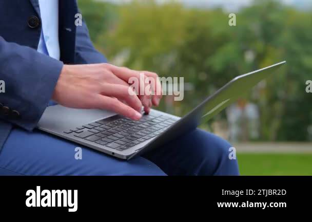 Close up footage of young man hands working on laptop tapping on ...