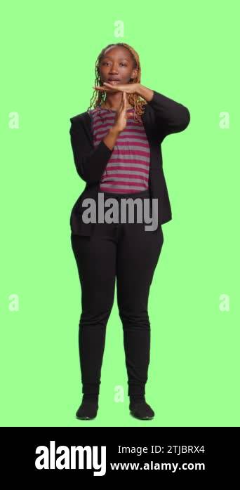 Vertical video: Full body of woman doing t shape timeout symbol on ...