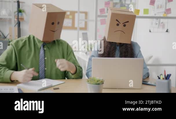 Office workers with paper bag heads showing emoji working at project at ...