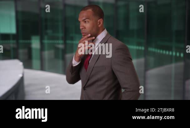 Smart African corporate employee thinking up a solution to a financial ...