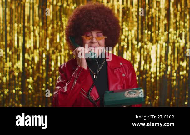 Crazy tourist hacker woman with lush hair coiffure talking on wired ...