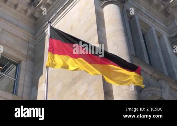 Flag of Germany on the roof of the Reichstag building. Fabric flags ...