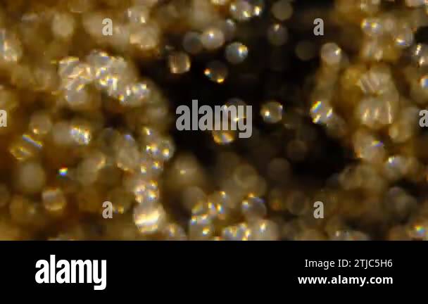 Golden glitter background. Beautiful transition with real gold particles. flying in wind on ...