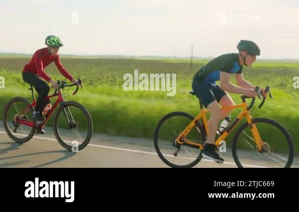 Professional cyclists wearing special sports equipment riding on modern ...