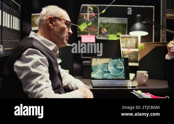 Private investigators on police duty, comparing surveillance photos and ...