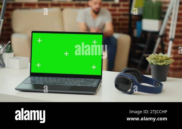 Empty office desk with laptop and isolated greenscreen template, using chroma key display with ...