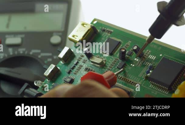 Technician testing mother board with circuit test repairing electronic ...