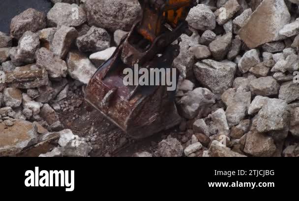 Excavator removing debris of collapsed structure. Shot in 4K RAW on a ...