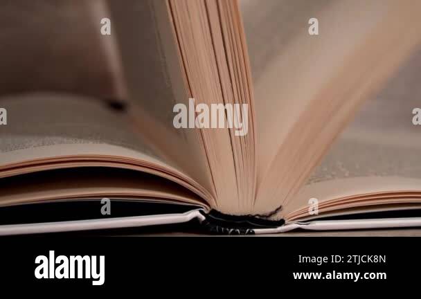 Turning pages in a white book close up slow mo. Reading a book ...