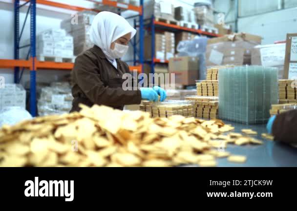 Rows of toppings for chocolates manufactured by machine, on a conveyor ...