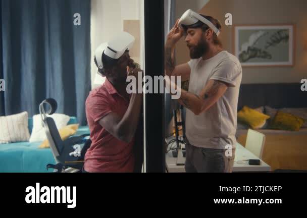 Angry multi ethnic men in VR headsets hit the wall with hands, yell at ...