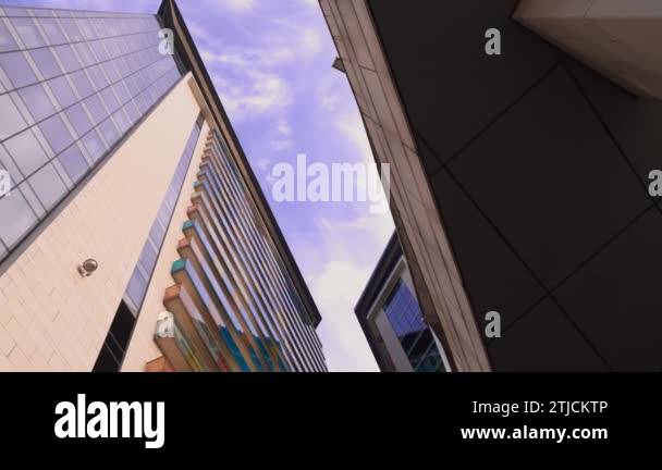 Narrow passage between modern residential buildings. Walls of high-rise ...