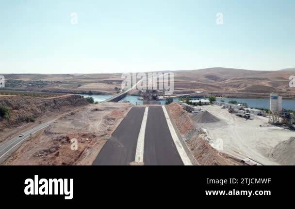 Road under construction and unfinished bridge. Newly built asphalt road ...