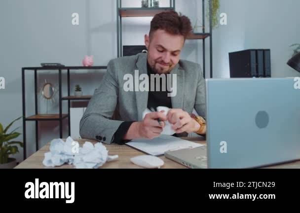 Angry furious man working at home office throwing crumpled paper ...