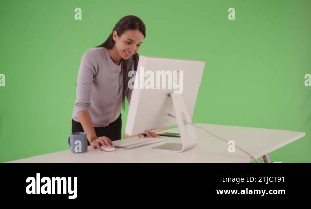 Happy excited Hispanic business woman raising arms in celebration while looking at computer ...