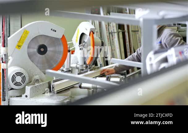 Cutting PVC profile with circular saw, plastic windows manufacture ...