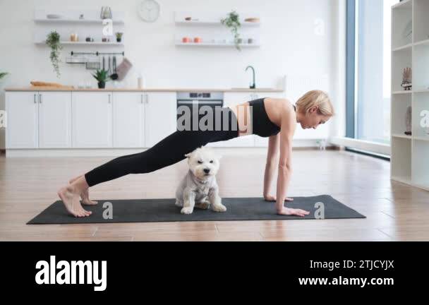 Happy caucasian woman improving balance with Side Plank Pose with ...