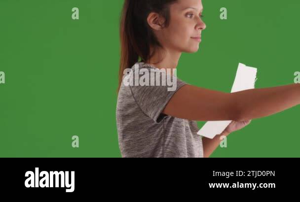 Close view of beautiful girl reading inventory list and handling goods ...