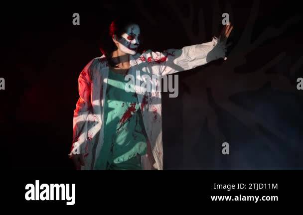 Young woman portrays bloodthirsty zombie with horror wounds on her face ...