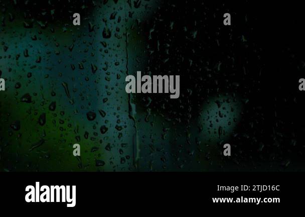 Rain drops on the glass. Small raindrop rests on glass while raining ...