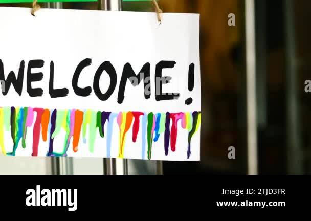welcome hand written text on paper hanging on cafe door Stock Video ...