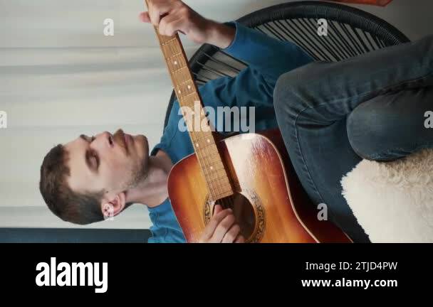 Musician playing acoustic guitar at home. Guitarist playing chords ...