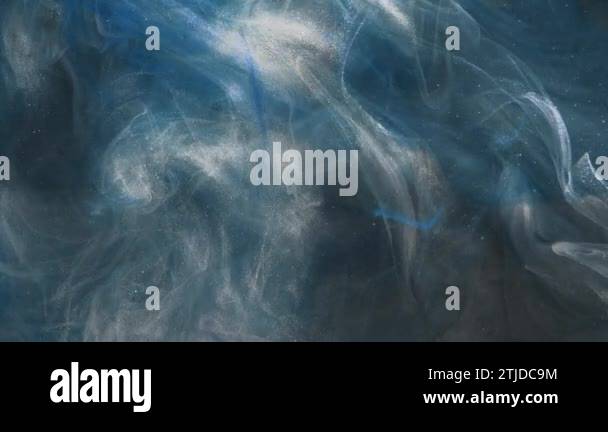 Glitter mist. Ink water. Creative intro. Blue silver gray color glowing ...