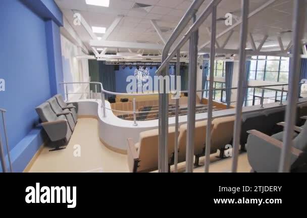 Steps with handrails and soft chairs on terrace in empty concert hall ...