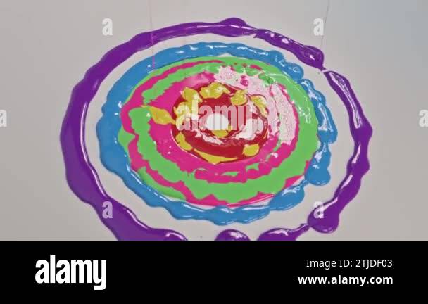 The colors that drip on top of each other blend together to create an ...
