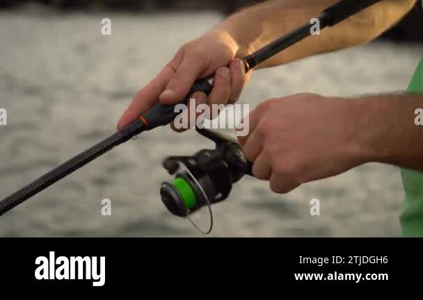 Angler throwing the rod into the sea and picking it up, performs rapid ...
