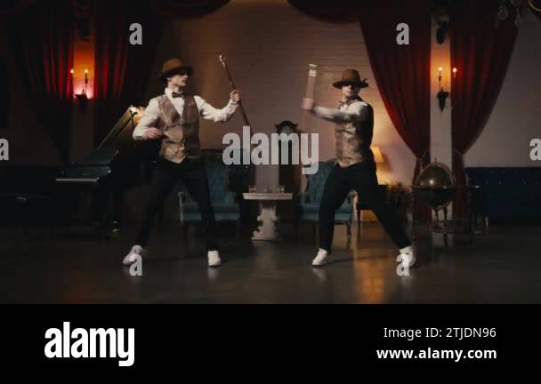 Two stylish professional male dancers in classy dandy hat performing ...