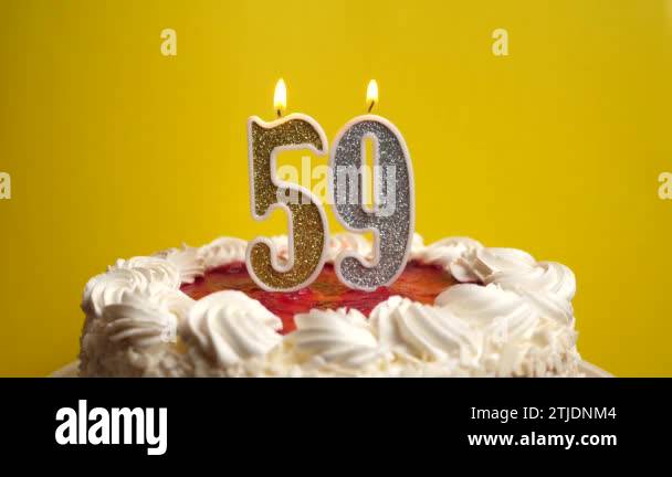 They blow out a candle in the form of the number 59, which is stuck ...