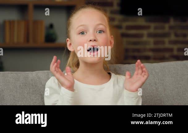 Young preteen girl pretty funny kid looking surprised at camera with big eyes open mouth in ...