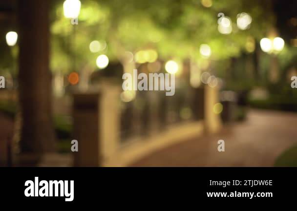 Out of focus video background plate of curved sidewalk in urban park at ...