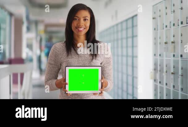 Portrait of attractive black female at post office holding tablet with ...