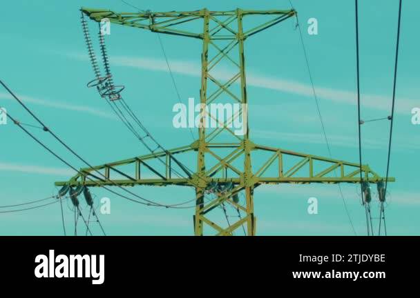 Power lines with sun rays on blue sky. High voltage substation ...