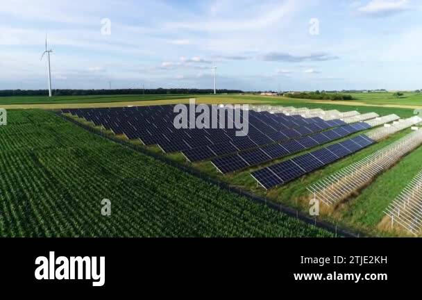 Building Solar Farm. Solar energy panels, aerial view of photovoltaic and wind turbines. Solar ...