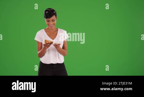 Stylish black female eating a slice of delicious pizza for lunch on ...