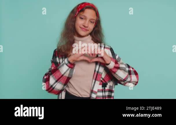 I love you. Smiling young teenager child girl kid makes heart gesture ...