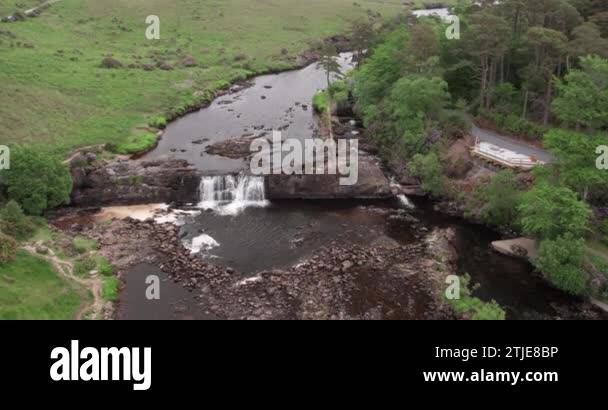 Scenic 4K aerial video of flying above spectacular waterfall and around ...