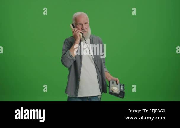 Green Screen. An Old Man with a Gray Beard is Talking on a Vintage ...