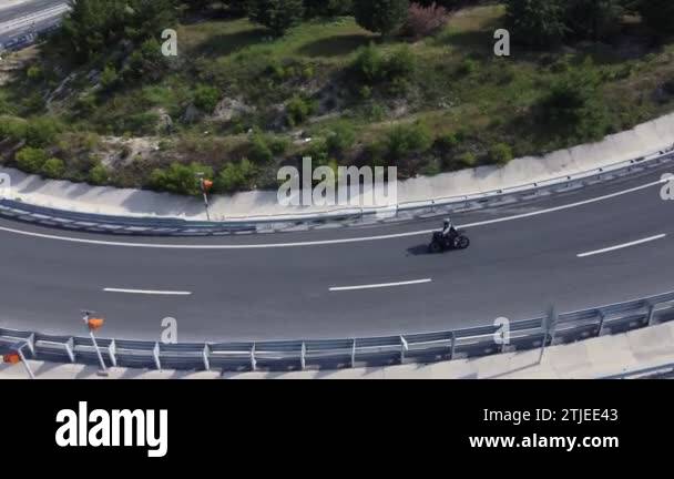 Overhead drone footage captures three racing motorcycles gracefully ...