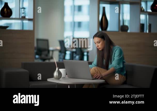 Attentive ceo working laptop sitting sofa closeup. Busy boss thinking ...