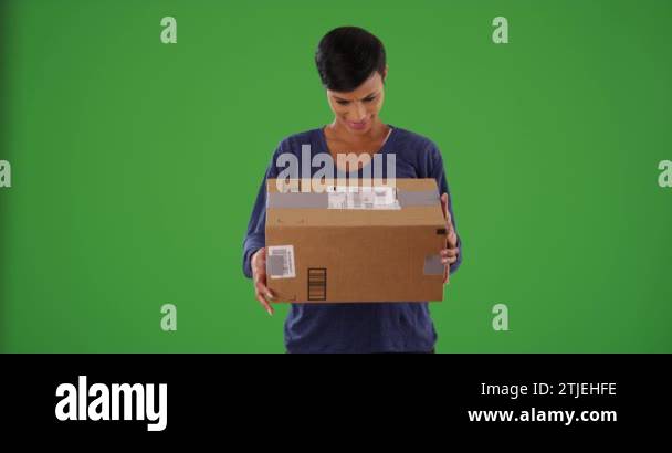 Beautiful black female shaking cardboard box excitedly, guessing what's ...