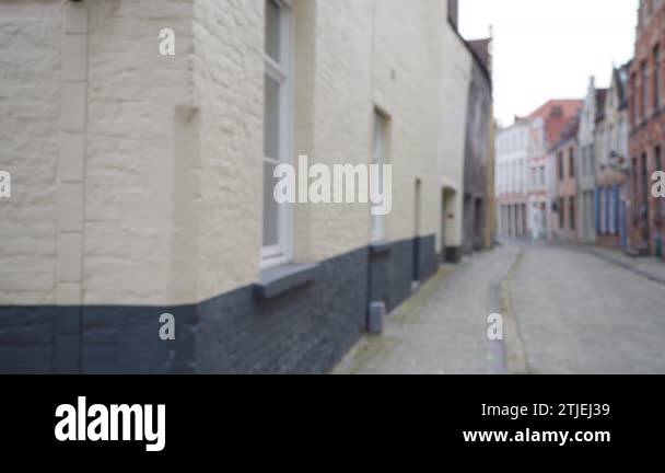 Out of focus background plate of alley with cobblestone street in ...