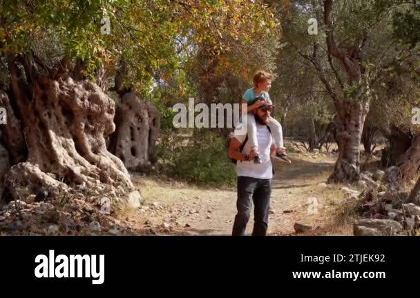 Travel with people. Caucasian father and his child boy or girl walking together exploring path ...