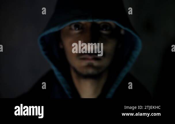 Horror film-like footage of a scared frightened boy looking sideways ...