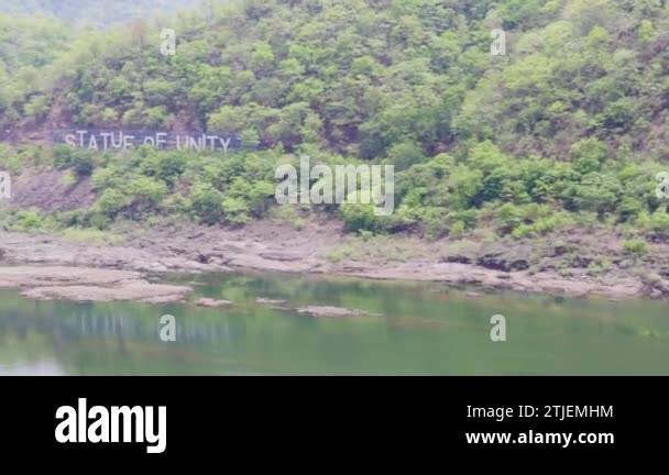 statue of unity board written at green mountain with river at morning ...