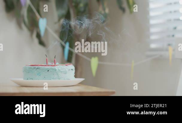 Birthday cake with smoke from candles that were just blown out. Shot in ...